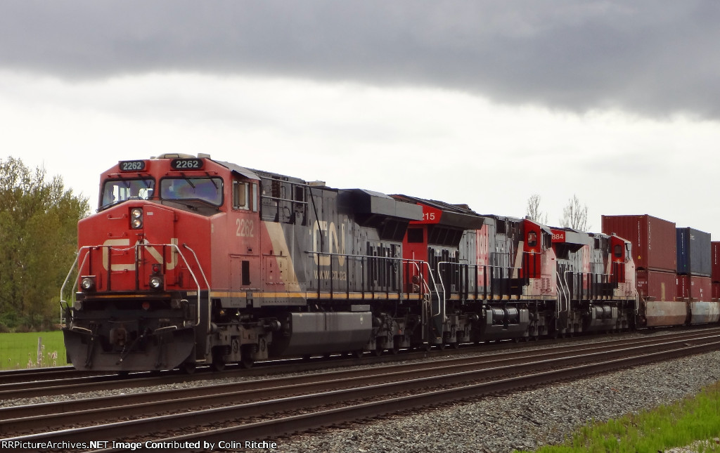 CN 2262/3215/3884 departing Fisher Siding EB, with a unit stack train